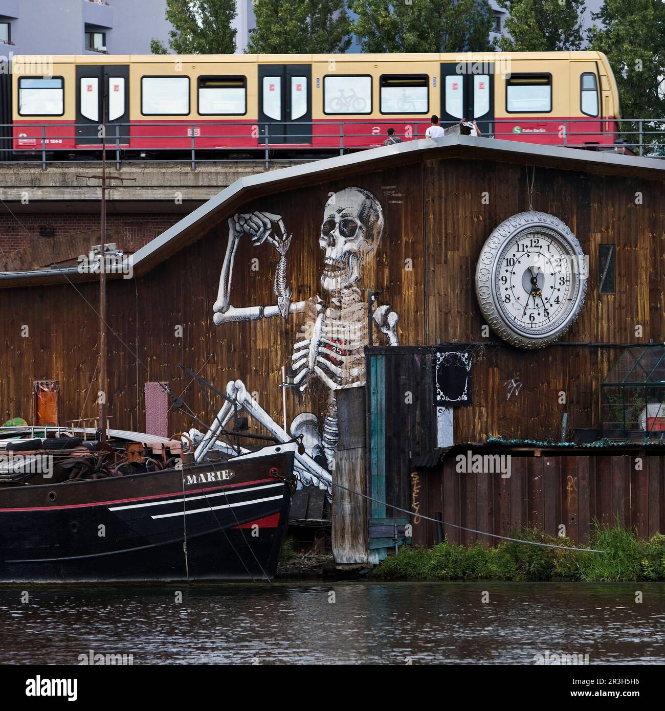 Scene on the Spree with a ship and a moving S-Bahn, Friedrichshain ...