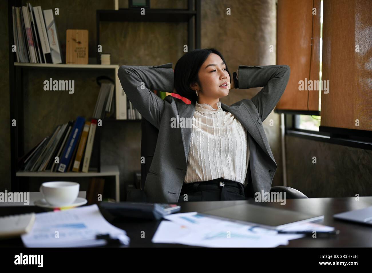 Relaxed and successful millennial Asian businesswoman or female boss ...