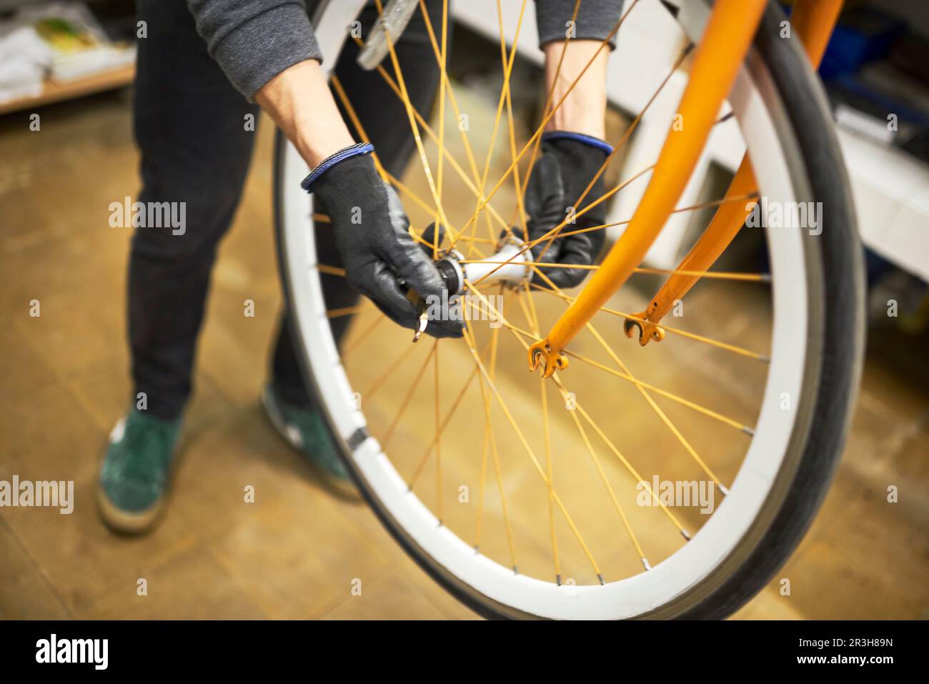 Maintenance of a bicycle: hands of an unrecognizable man using gloves ...