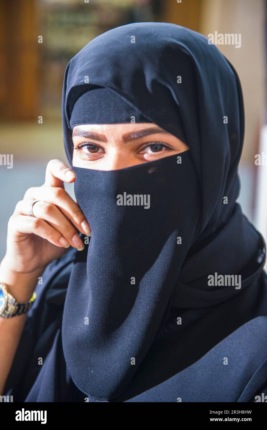 Veiled woman in the bazaar Souk Al-Mubarakiya, Kuwait City, Kuwait ...