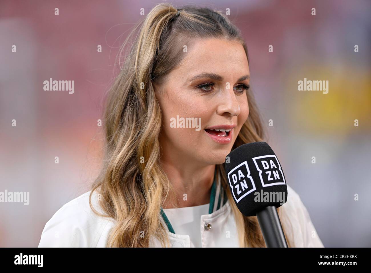 Presenter Laura Wontorra in interview with microphone, mic, DAZN, logo ...