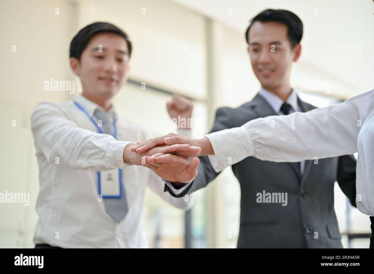 Close-up image of businesspeople putting their hands together after the ...