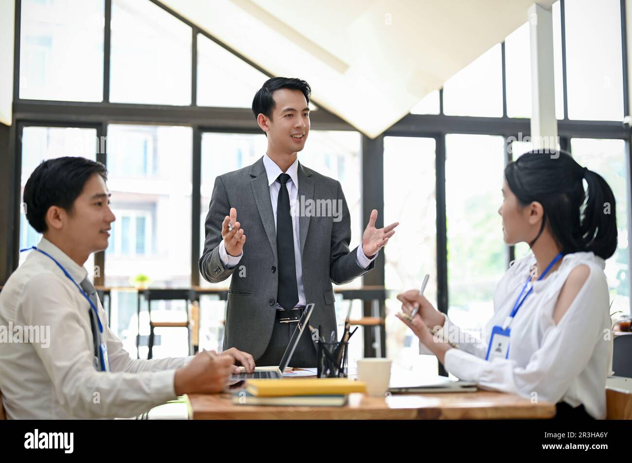 A professional Asian businessman or business coach is training and ...