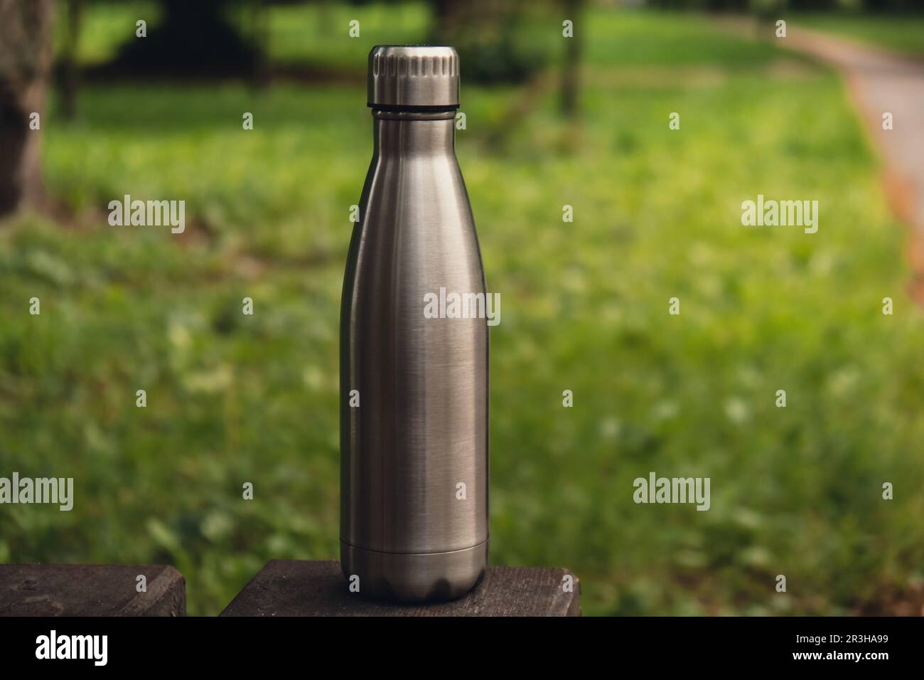 Water bottle. Reusable steel thermo water bottle on green grass ...