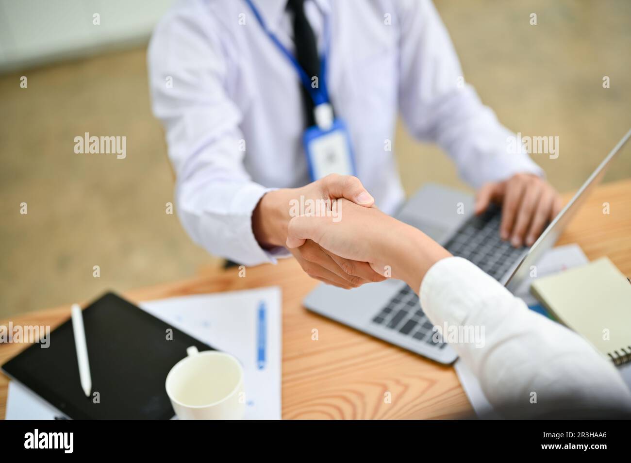 Close-up image of a businessman or male banker shaking hands with his ...
