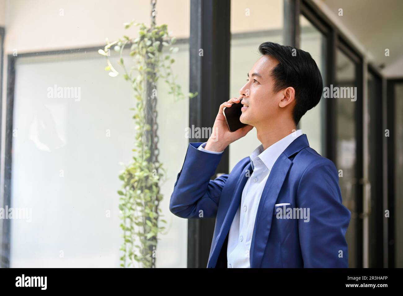 A successful and handsome millennial Asian businessman or male CEO in a ...