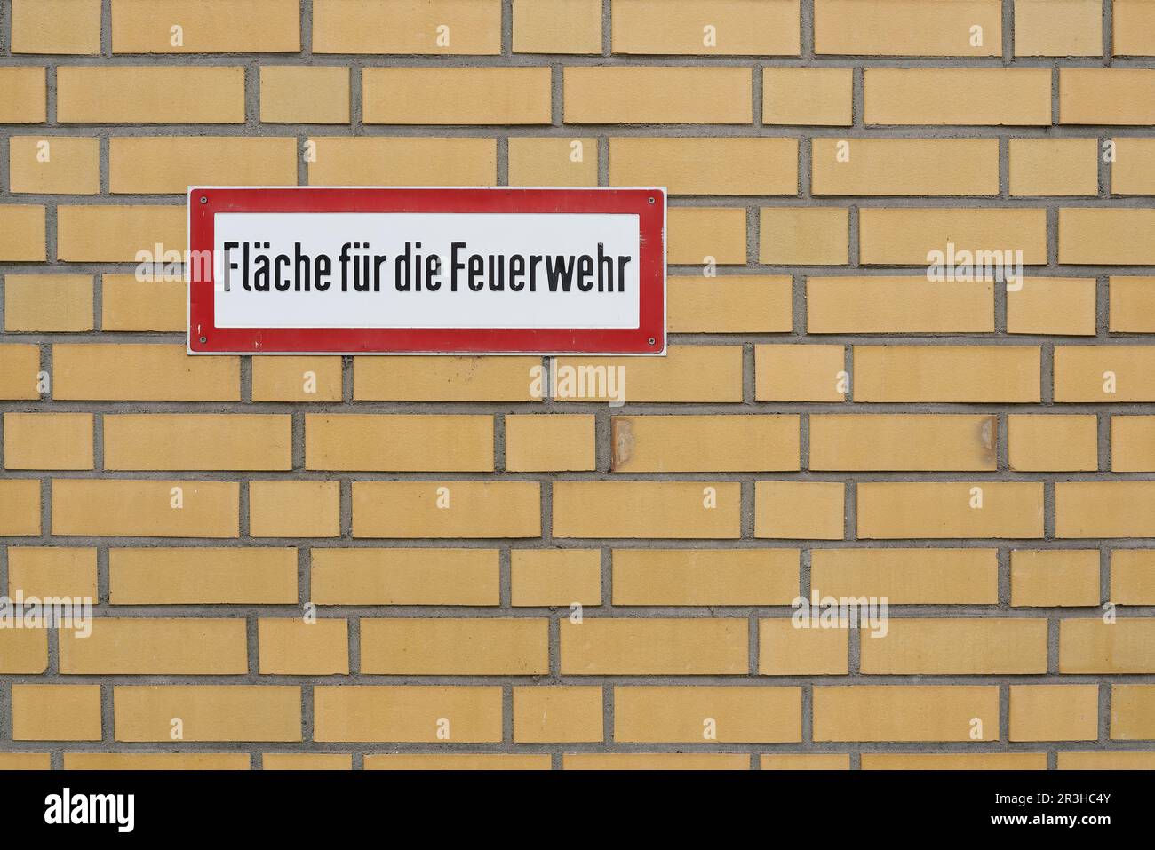 Warning sign on the facade of a house. Translation of the text: Area ...