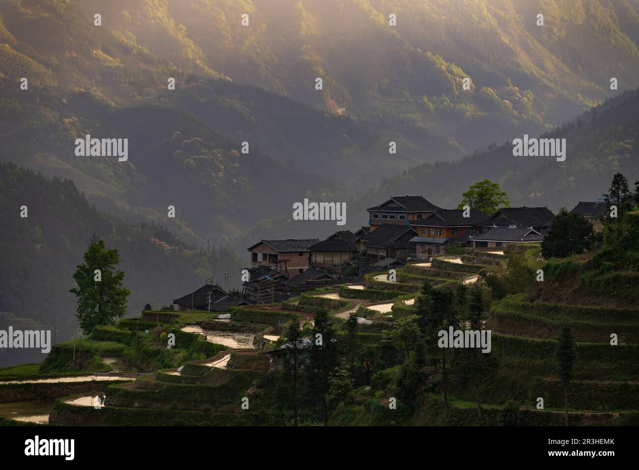 village houses and terrace fields on mountains in sunset Stock Photo ...