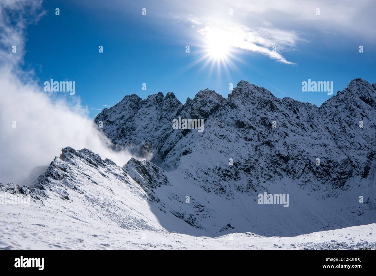 Panorama of Mountaineer standing on top of snowy mountain range at High ...