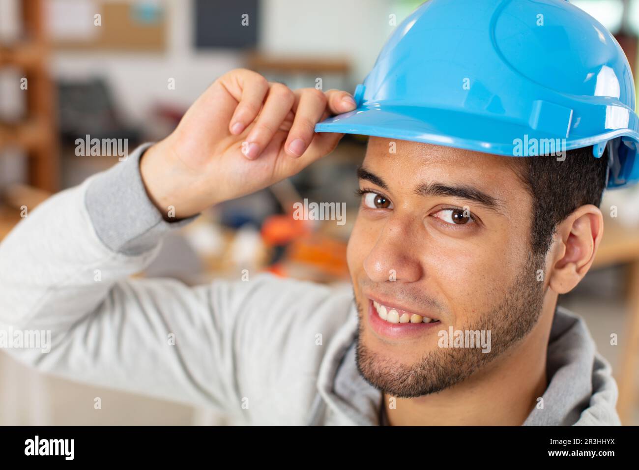 young construction worker wearing a hard hat Stock Photo - Alamy