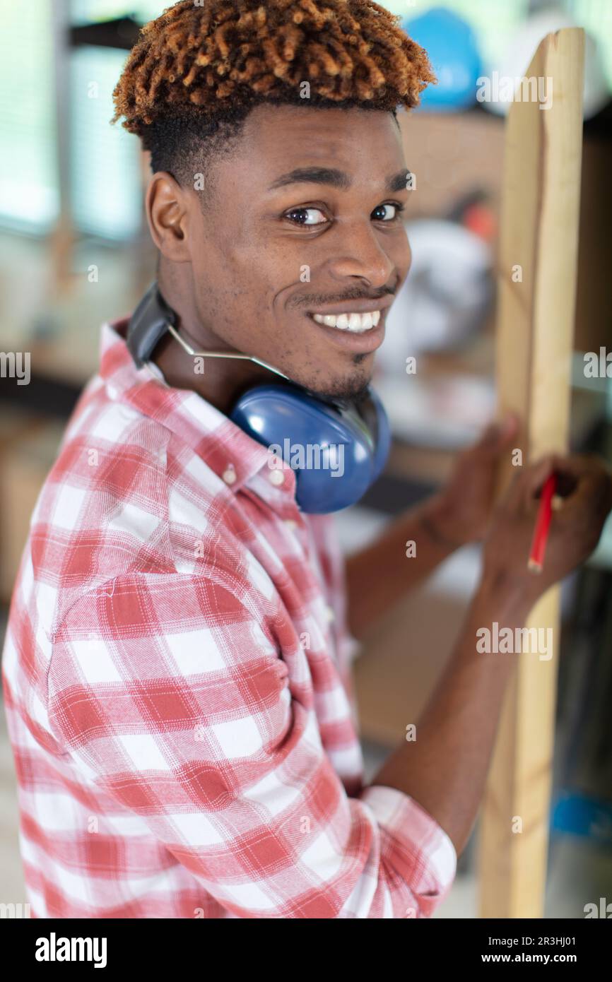 portrait of handsome carpenter with penci Stock Photo - Alamy