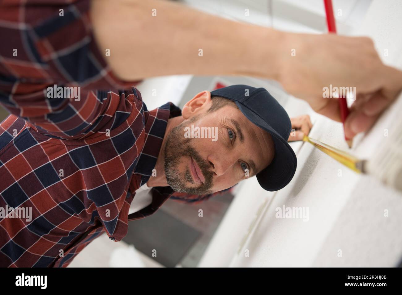 a man measuring cupboard door Stock Photo - Alamy