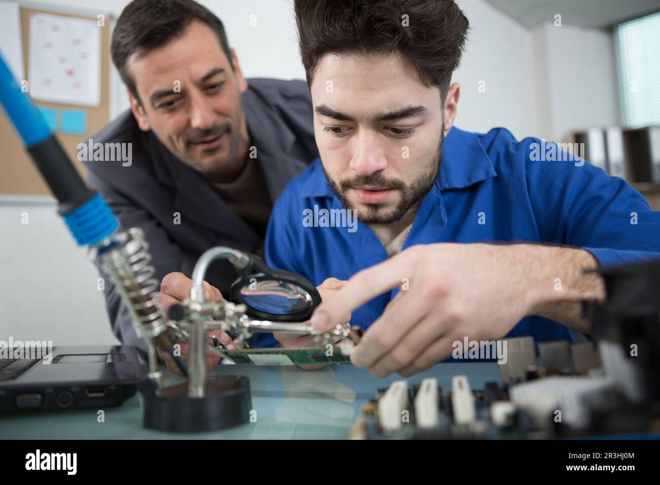 two men repairing a desktop computer Stock Photo - Alamy