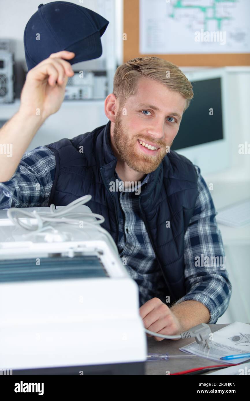 a young man fixing printer Stock Photo - Alamy