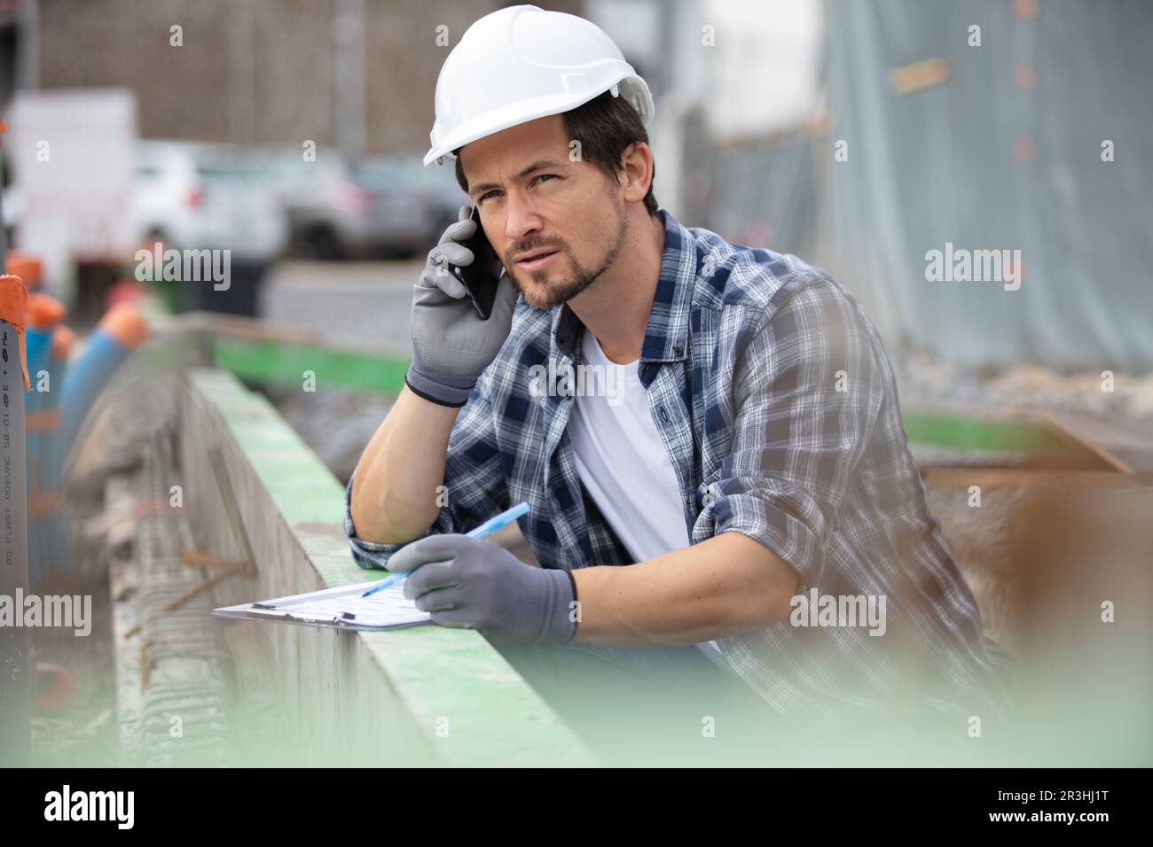 builder checking with his boss about construction project Stock Photo ...