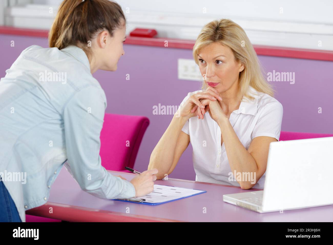 Smiling teacher talking one hi-res stock photography and images - Alamy