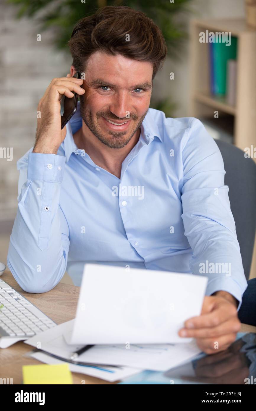 candid man in the office talking on the telephone Stock Photo - Alamy