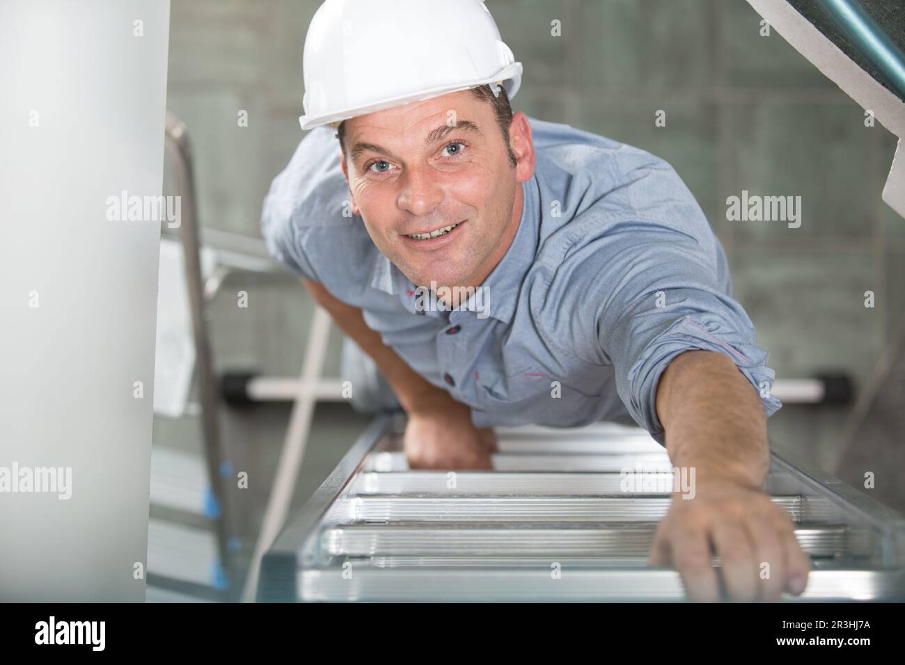 man going front on high ladder Stock Photo - Alamy