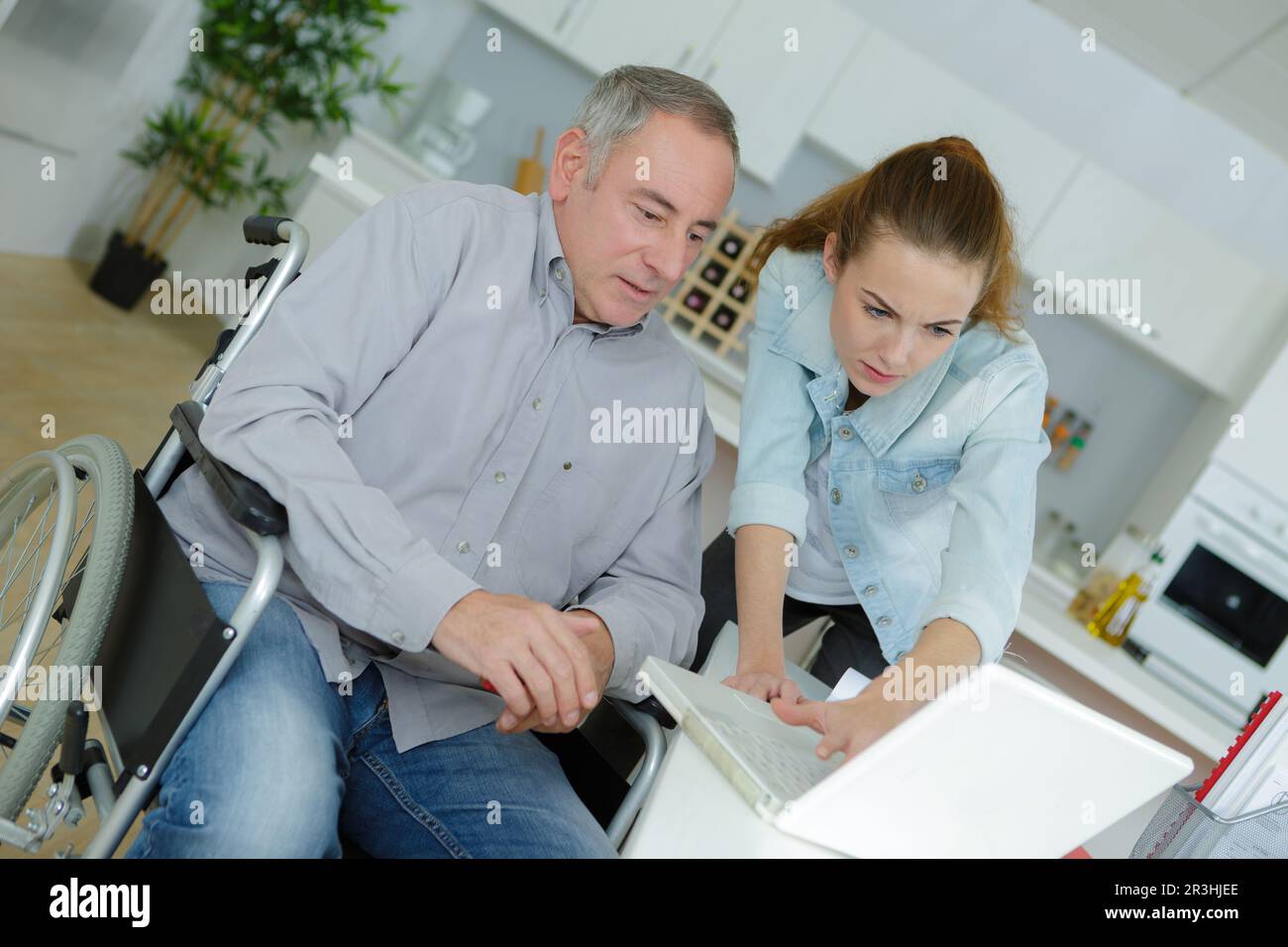 old man in geriatric hospice helped by young attractive woman Stock ...
