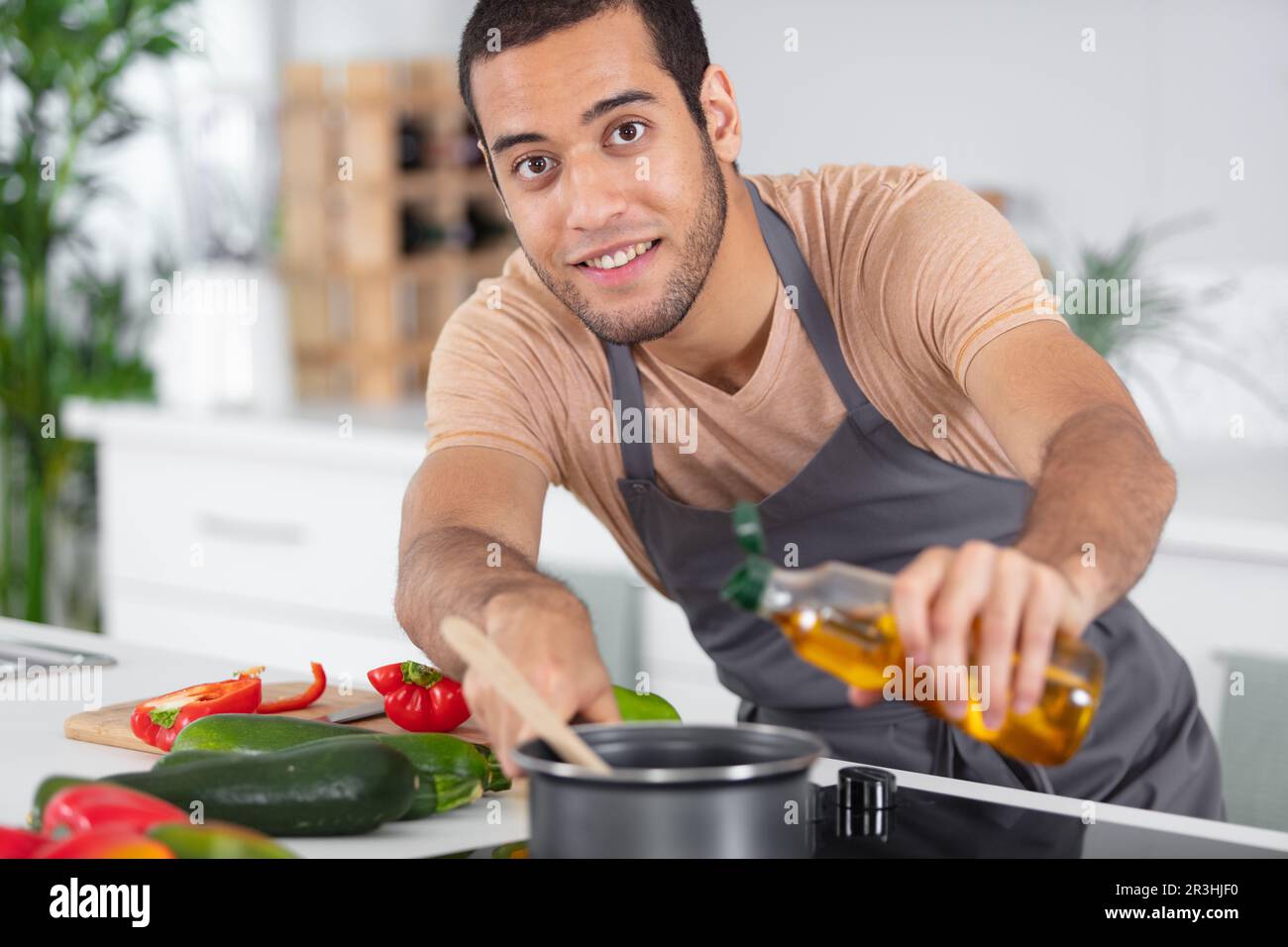 happy man cooking healthy food with recipe Stock Photo - Alamy