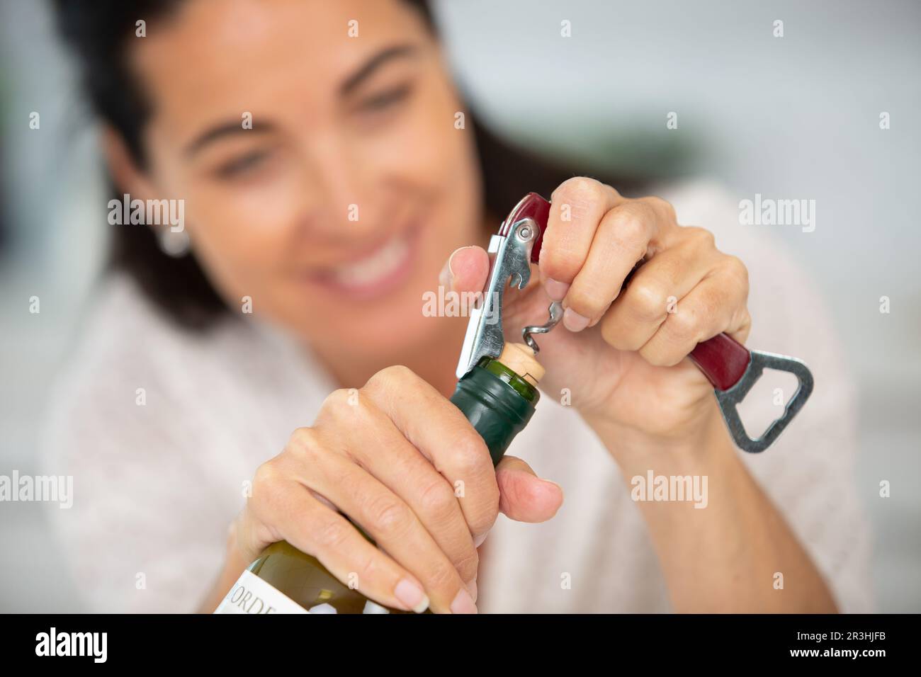 Beautiful woman opens bottle hi-res stock photography and images - Alamy