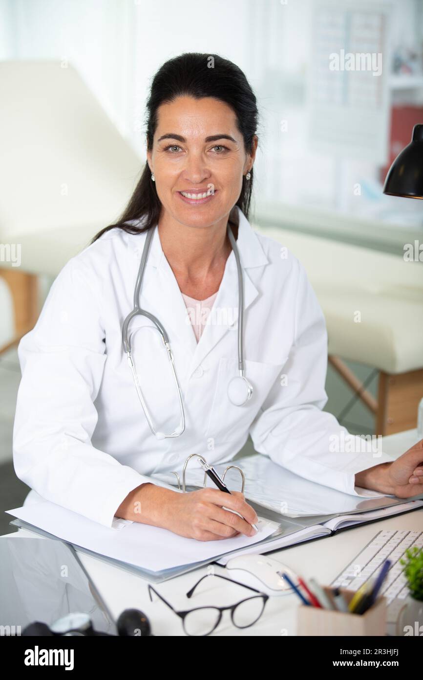 female doctor taking notes in office Stock Photo - Alamy