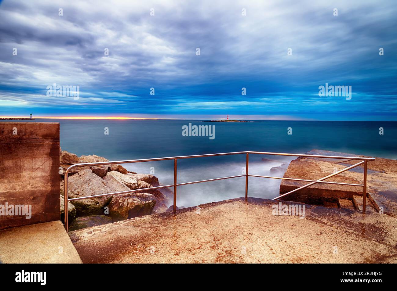 Sunset on breakwater with stairs Stock Photo - Alamy