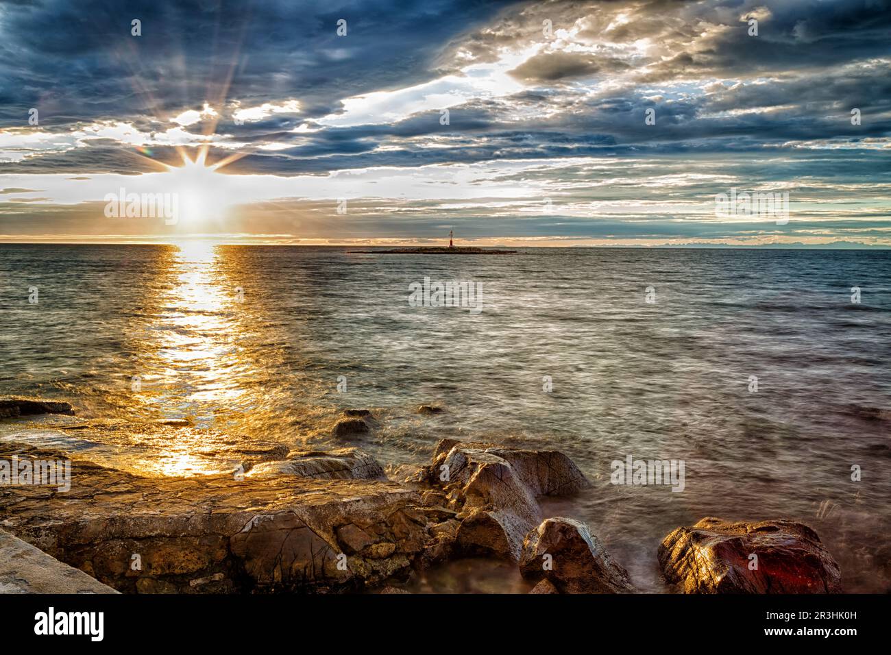 Sunset on sea rocks Stock Photo - Alamy