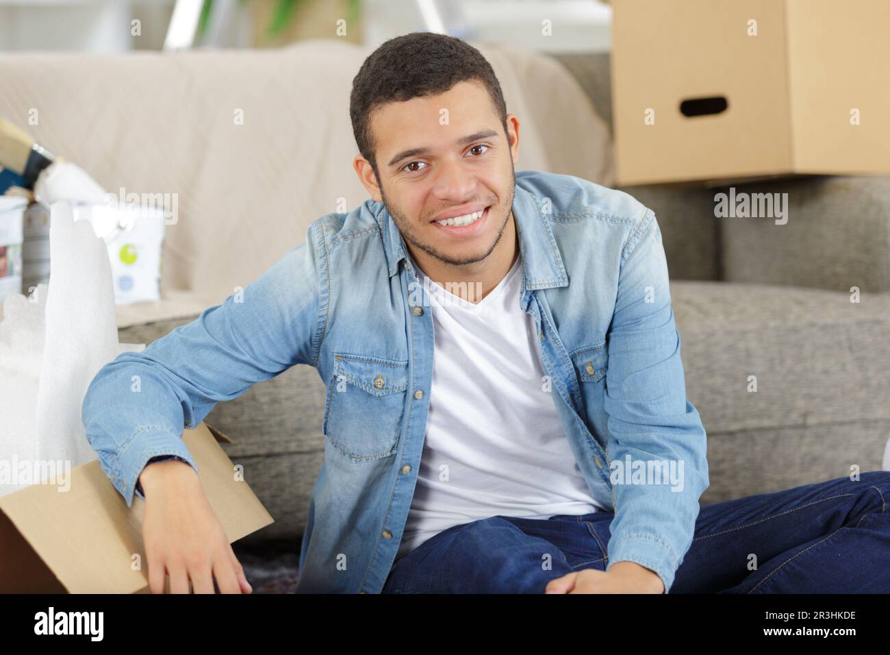 man with boxes and blueprint moving to new home Stock Photo - Alamy