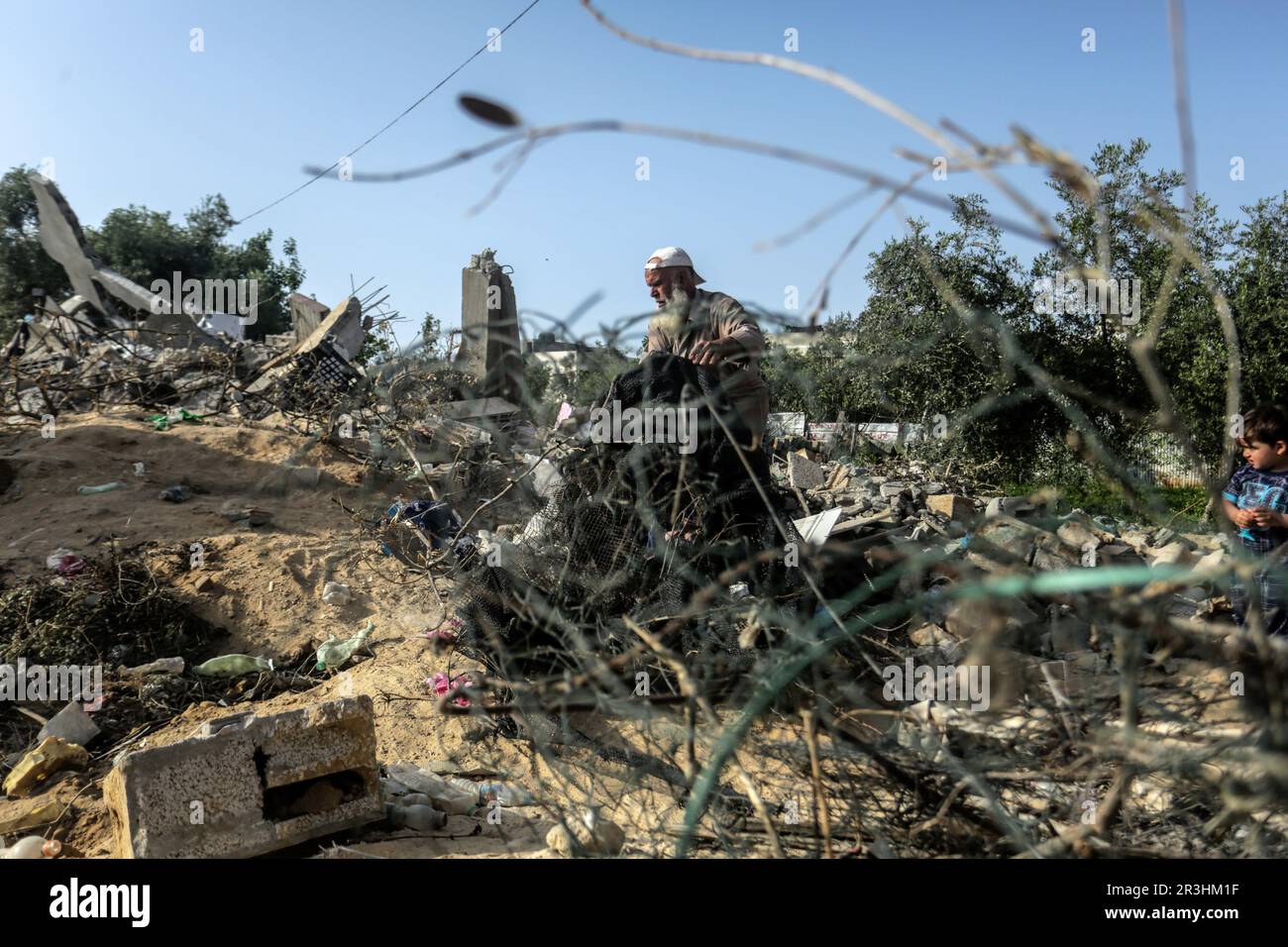 Gaza, Palestine. 23rd May, 2023. A man stands next to rubble of the ...