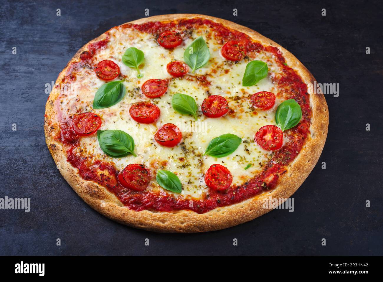 Traditional Neapolitan Italian pizza margherita with tomatoes and mozzarella served as close-up ...