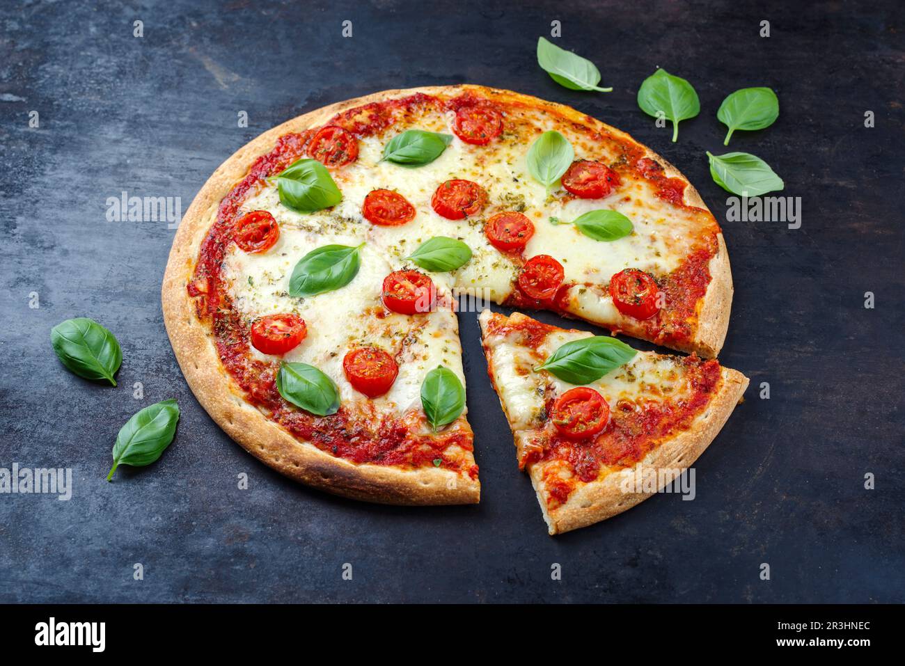 Traditional Neapolitan Italian pizza margherita with tomatoes and mozzarella served as close-up ...
