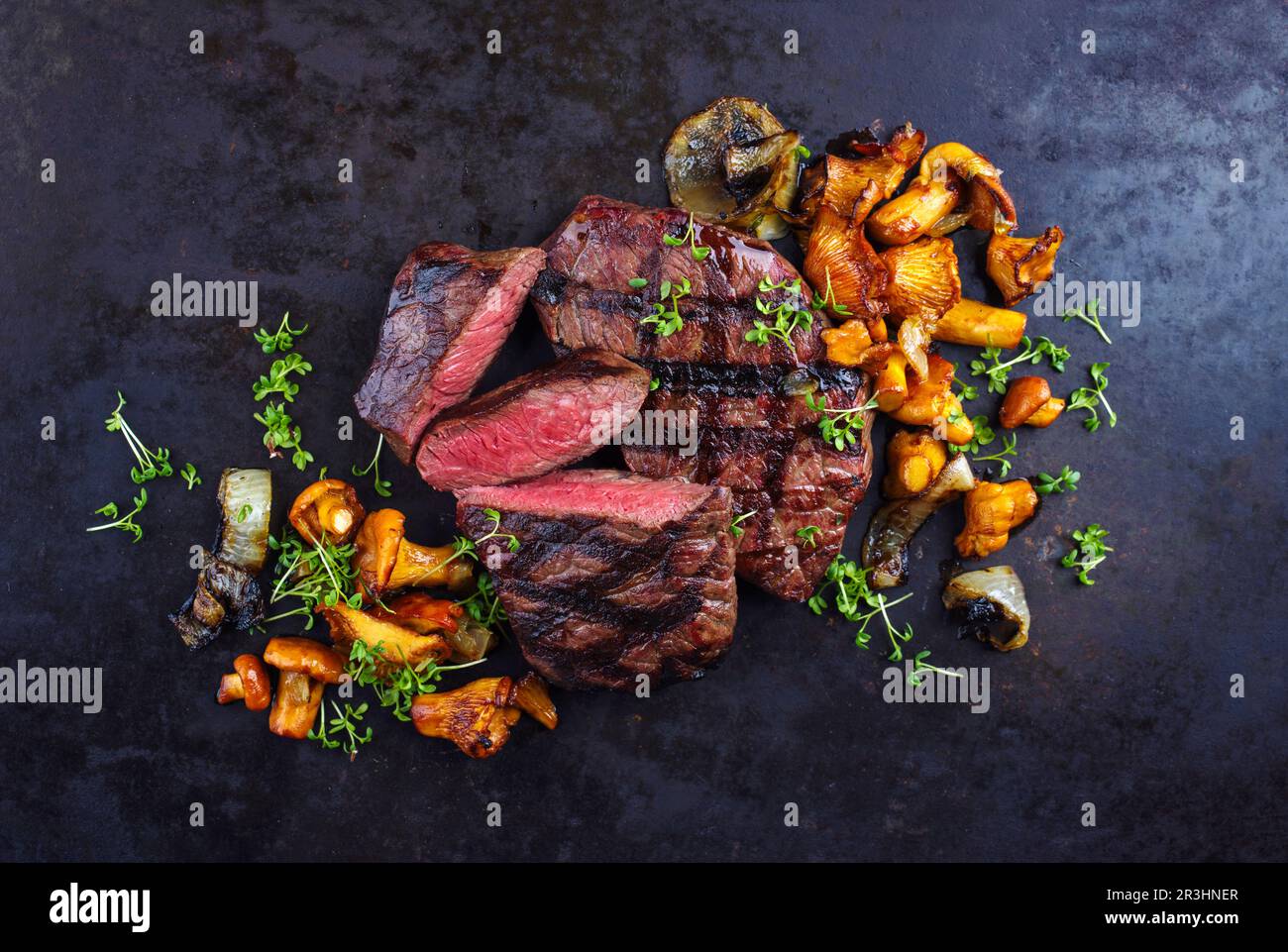 Barbecue angus sirloin beefsteak with chanterelles and onion rings ...