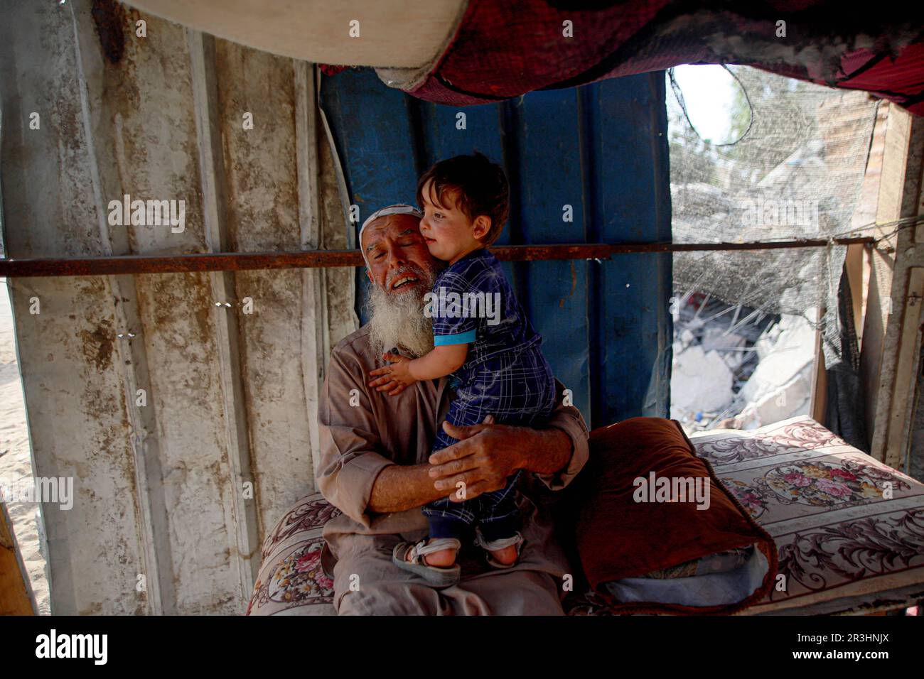 Palestine. 23rd May, 2023. A Palestinian man sits with his son next to ...