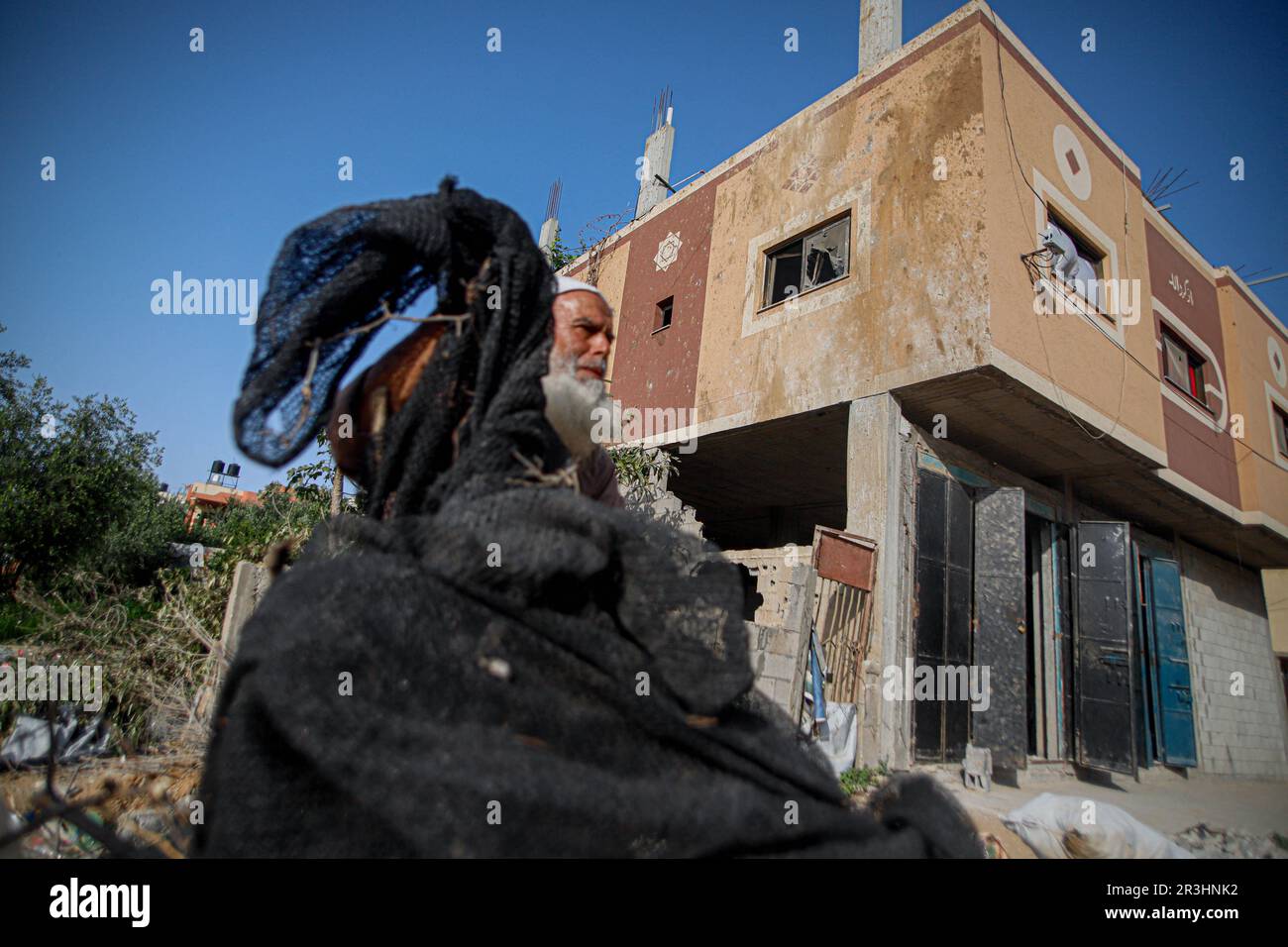 Palestine. 23rd May, 2023. A man stands next to rubble of the destroyed ...