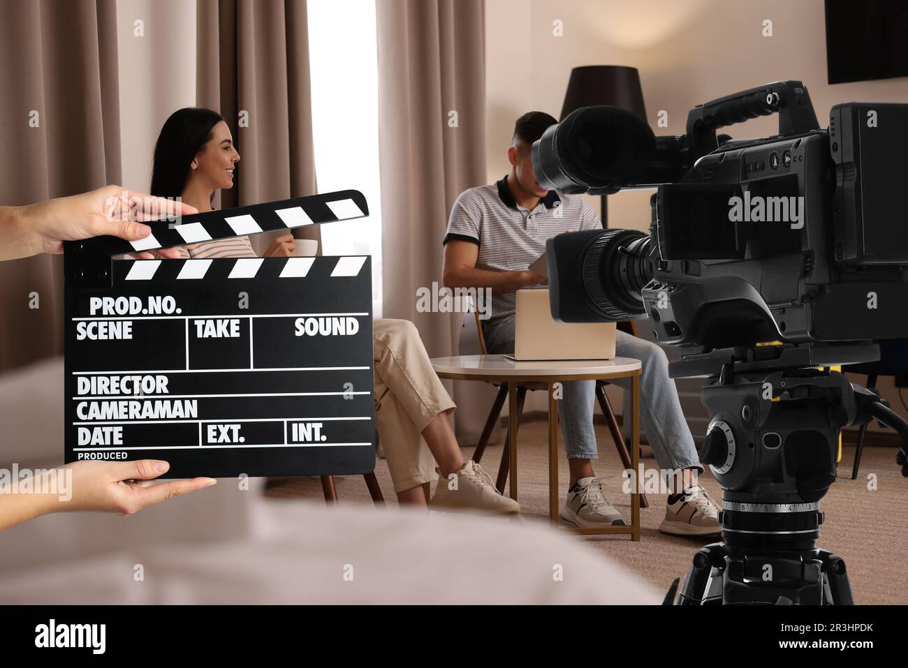 Shooting movie. Second assistant camera holding clapperboard near video ...