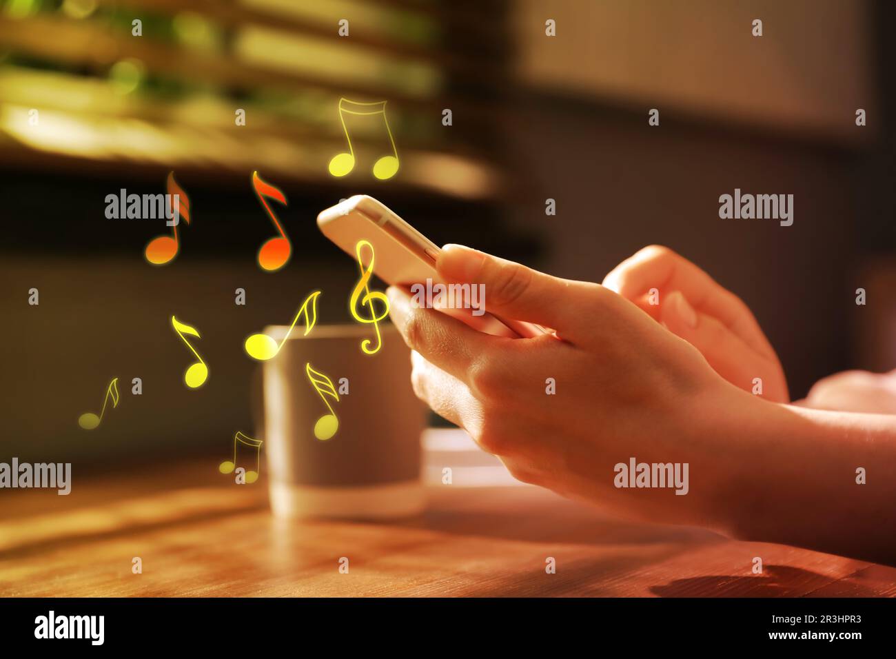 Woman listening to music on mobile phone indoors, closeup. Music notes ...