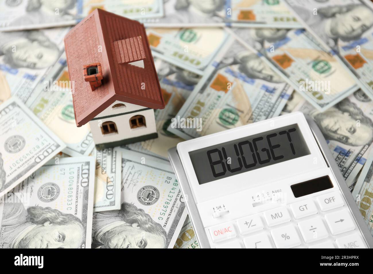 Budget plan. Calculator and house model on dollar banknotes Stock Photo ...