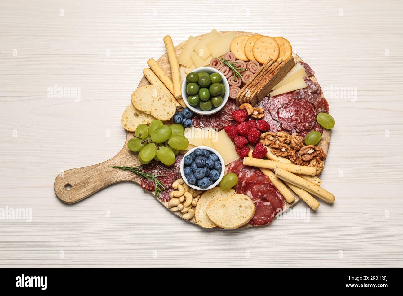 Tasty parmesan cheese and other different appetizers on white wooden ...