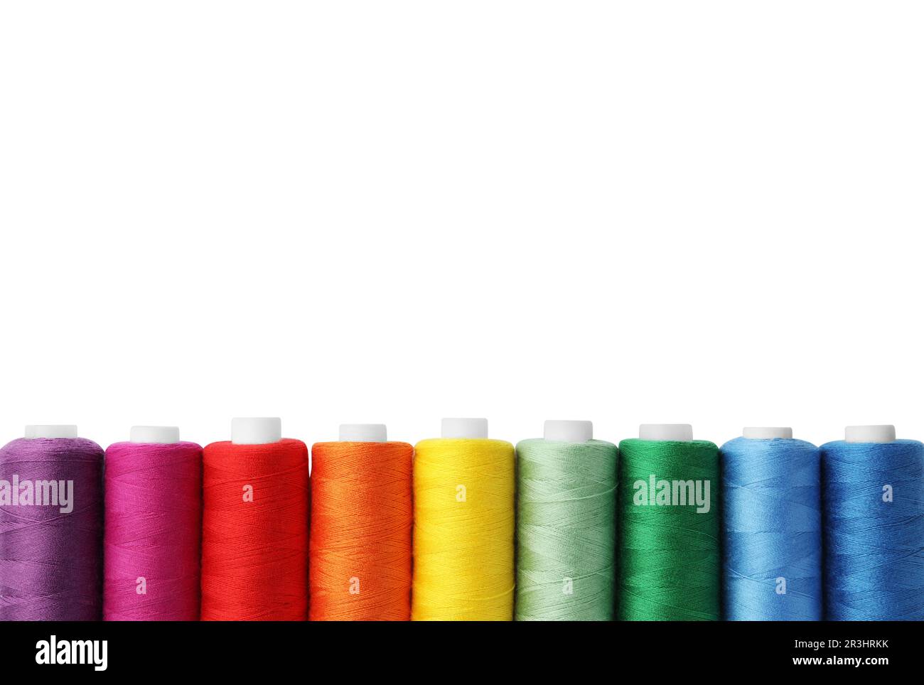 Different colorful sewing threads on white background, top view Stock ...