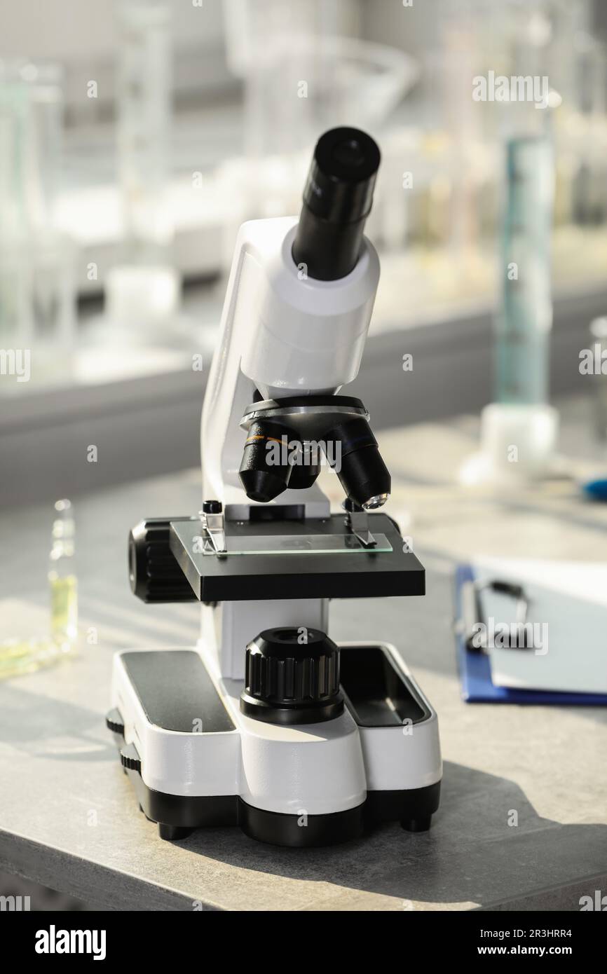 Modern medical microscope on table in laboratory Stock Photo - Alamy