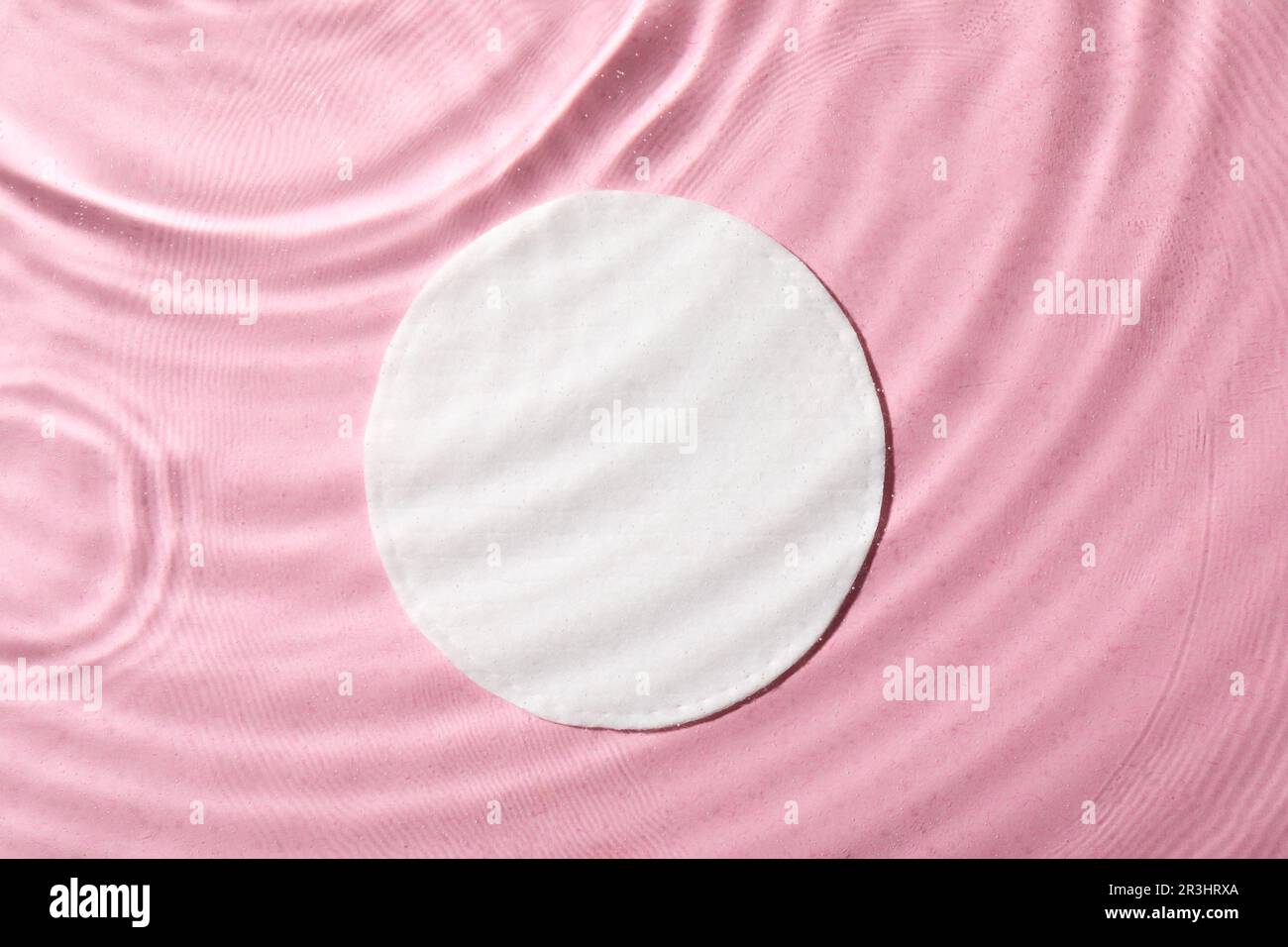 White cotton pad in water on pink background, top view Stock Photo - Alamy