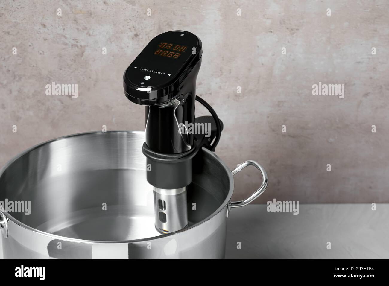 Thermal immersion circulator in pot on white table, space for text. Sous vide cooker Stock Photo ...