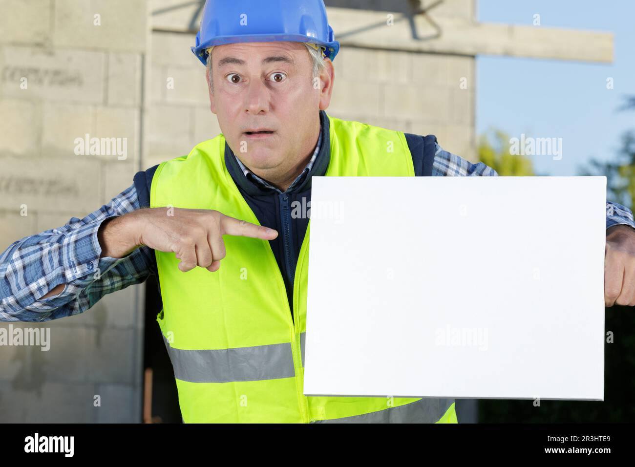 worker pointing his finger to a blank board Stock Photo - Alamy