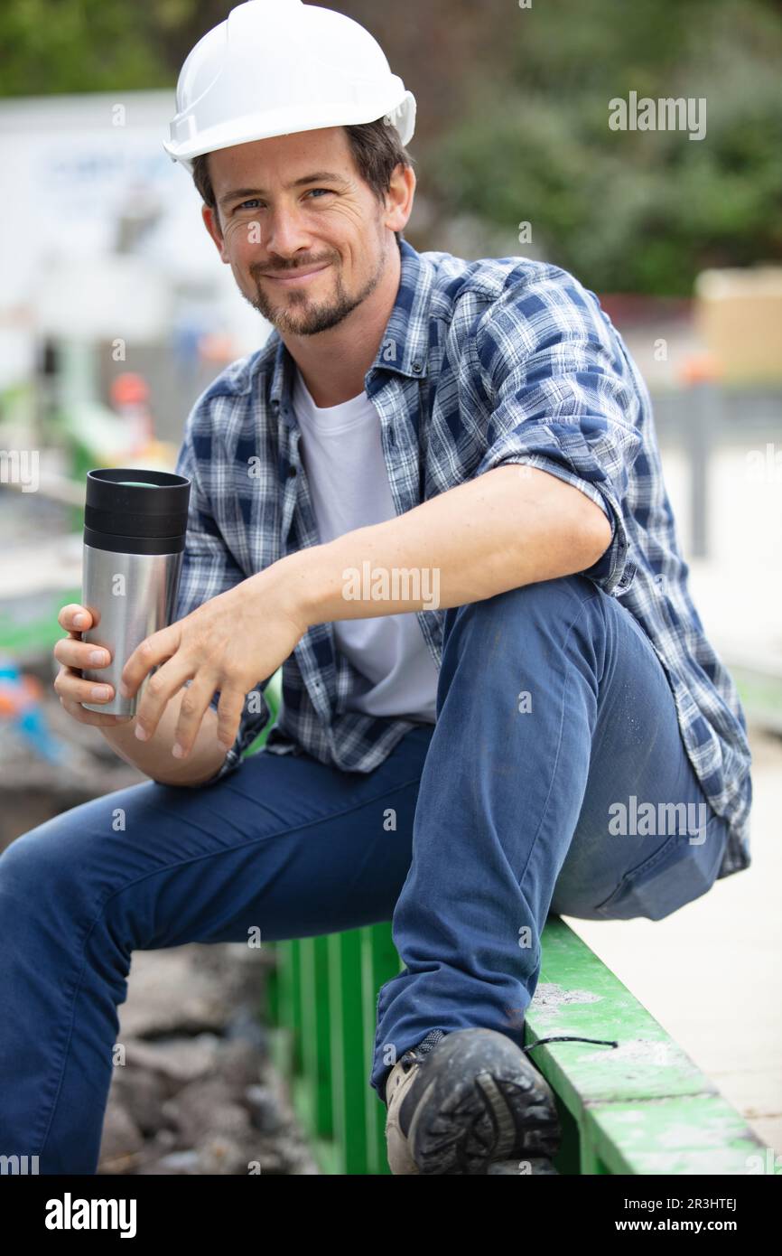 construction worker having a break on site Stock Photo - Alamy