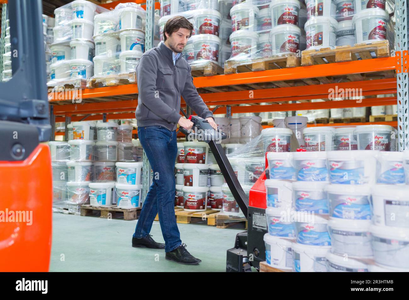 male warehouse worker moving a pallet Stock Photo - Alamy