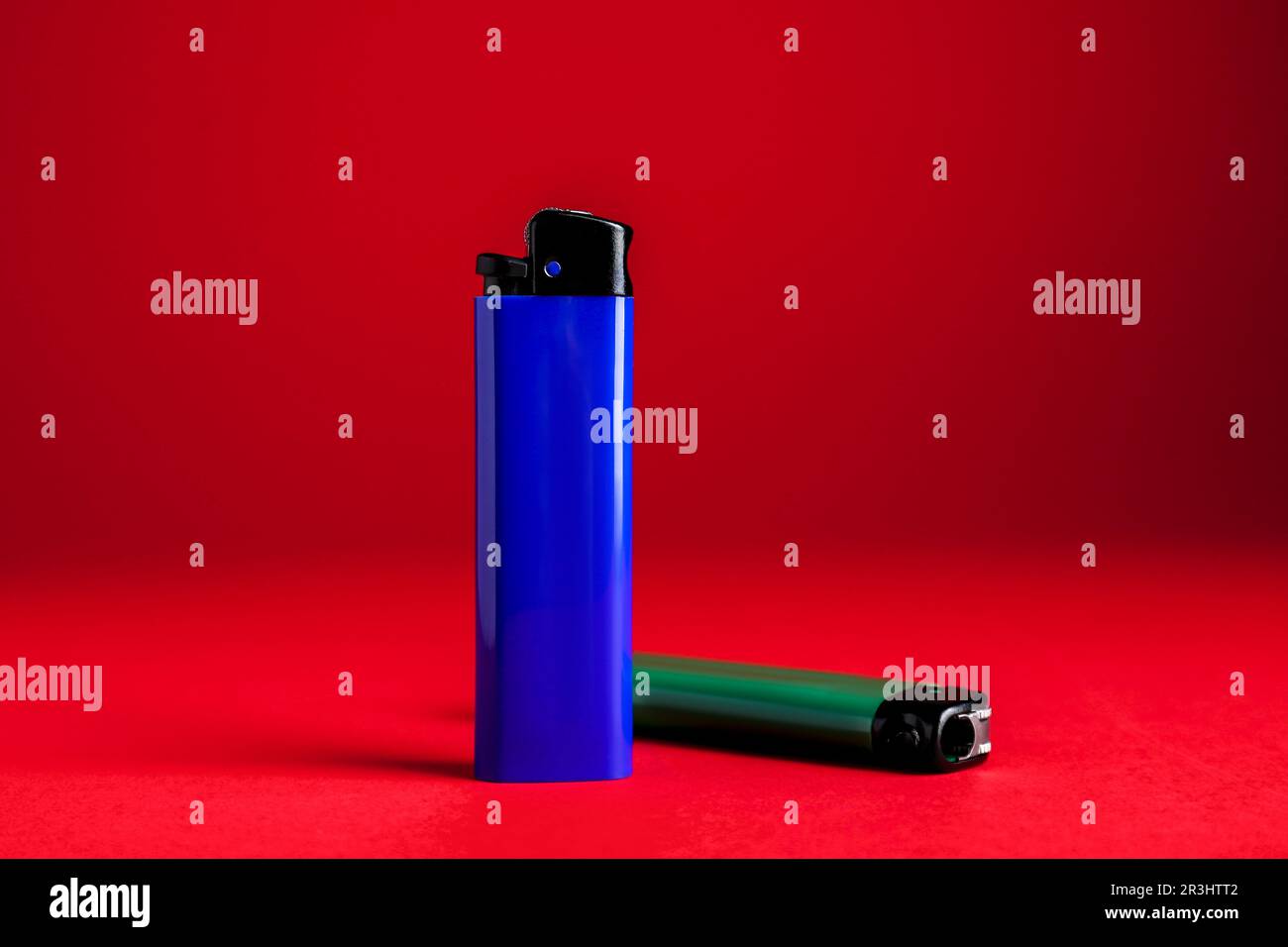 Stylish small pocket lighters on red background Stock Photo - Alamy