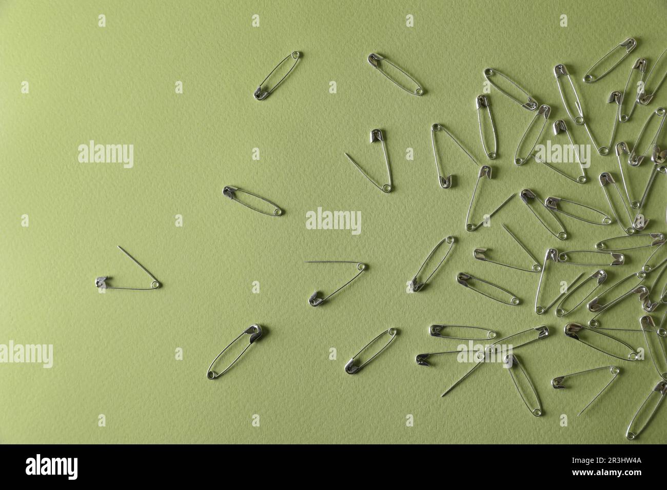 Many safety pins on green background, flat lay Stock Photo - Alamy