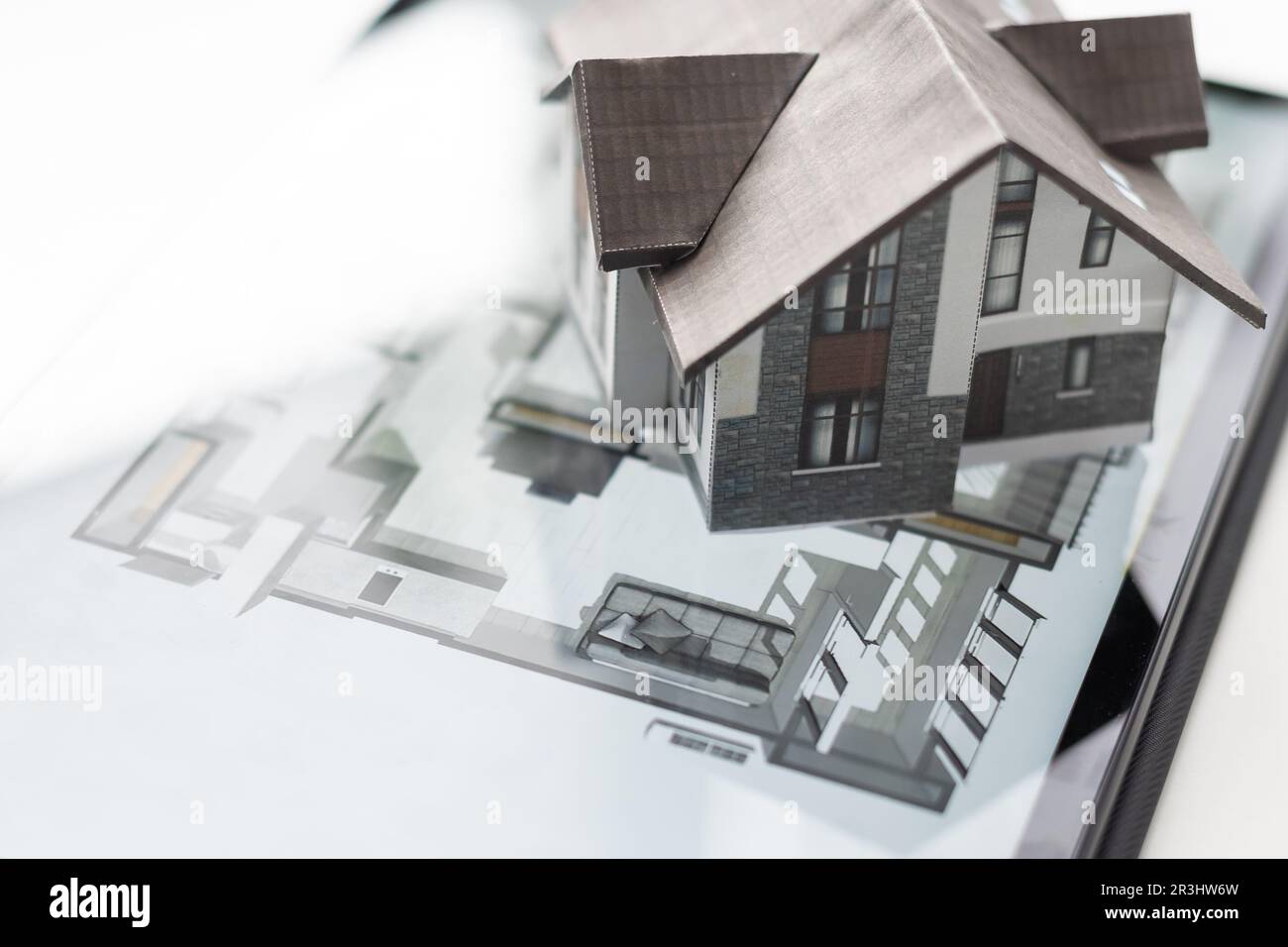 Small house model is on screen tablet and icons home electronics ...