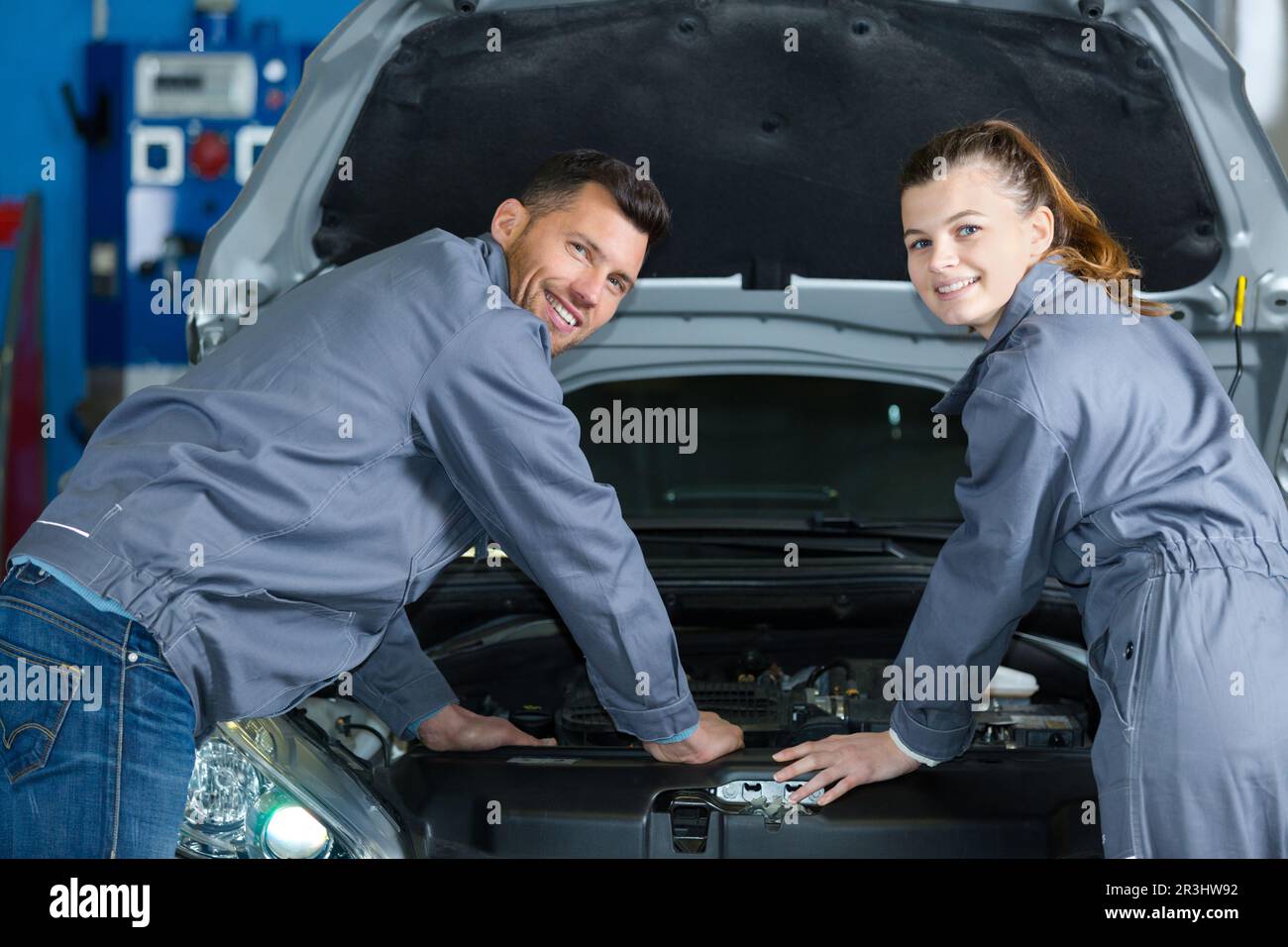 portrait of two happy mechanic posing Stock Photo - Alamy